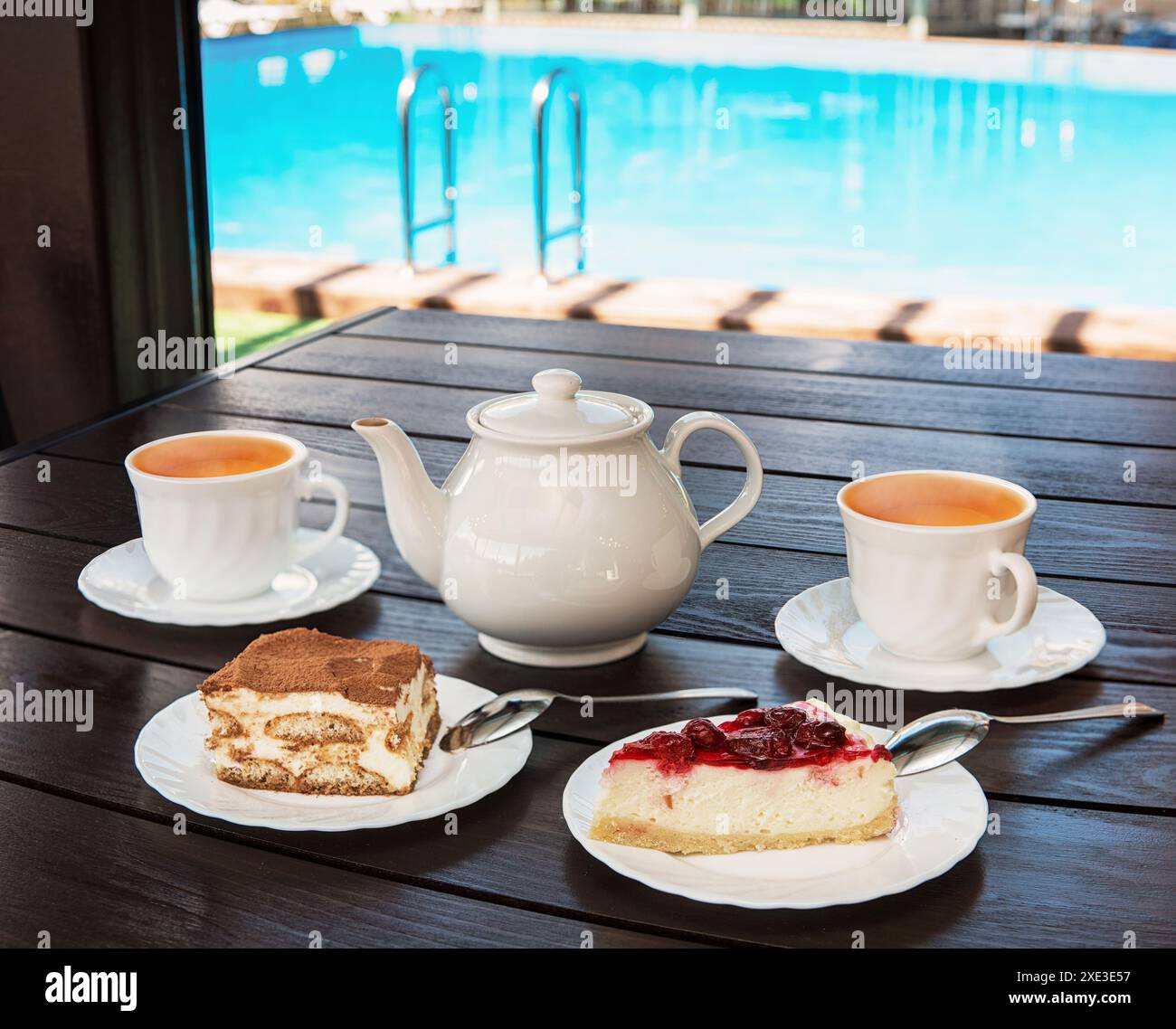 Afternoon tea set with hot tea and tasty cakes Stock Photo - Alamy