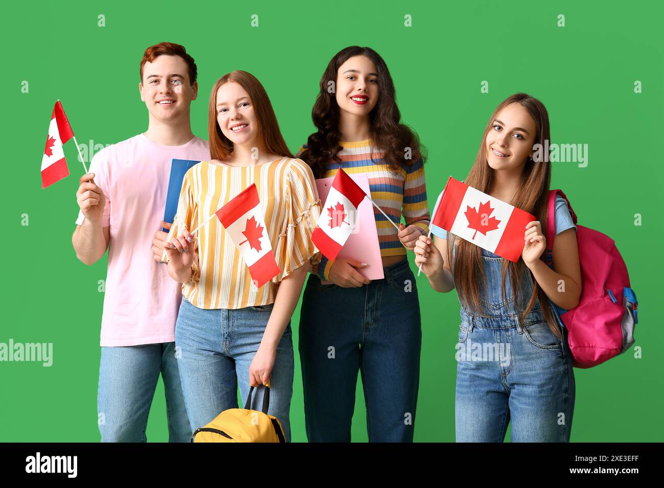 Group of students with flags of Canada on green background Stock Photo ...