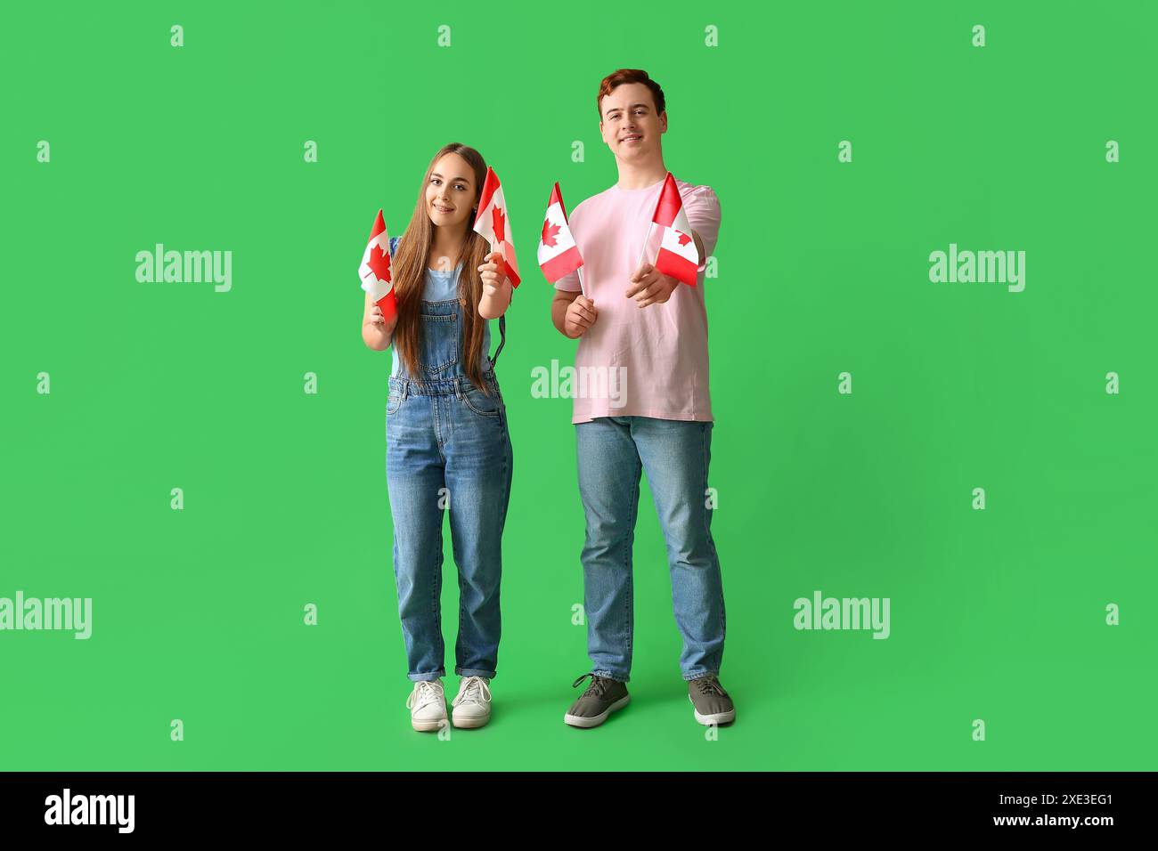 Students with flags of Canada on green background Stock Photo - Alamy