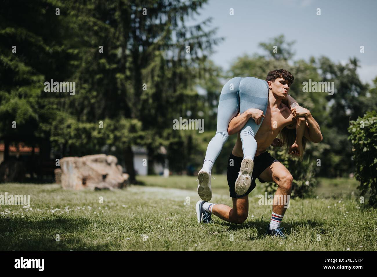 Strong man exercising with weights plus carrying his friend on his ...