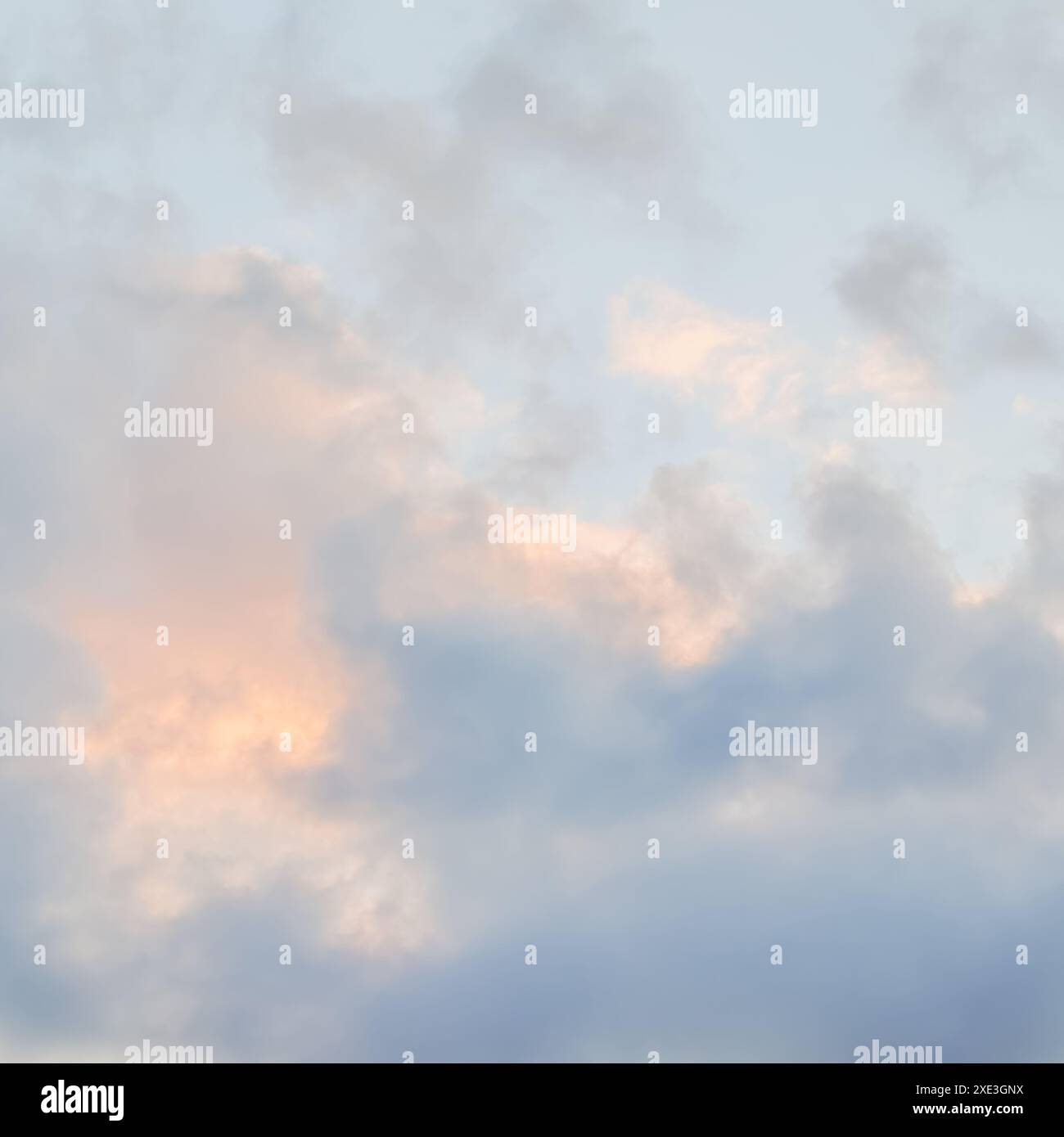 Blue sky background with pale pink clouds at sunset Stock Photo - Alamy
