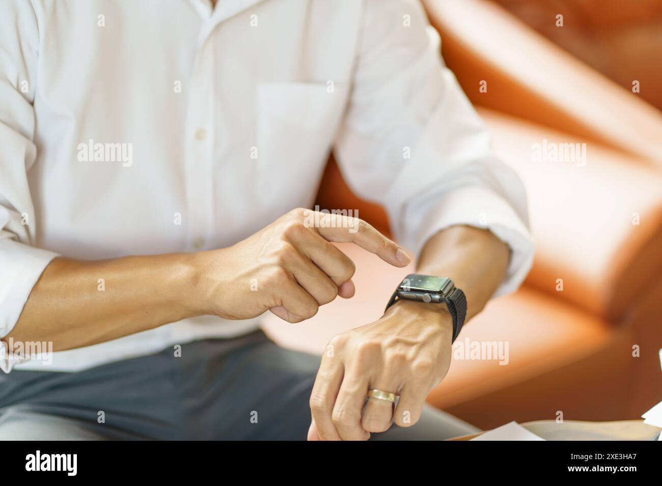 Business man Looking atÂ smart watch In Office online connect Gadget ...