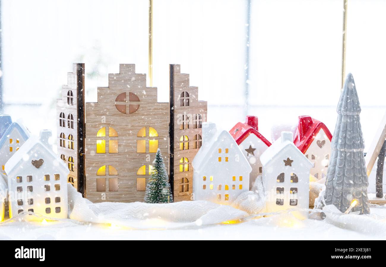 Cozy Christmas decor tiny house of small size on window sill with snow ...