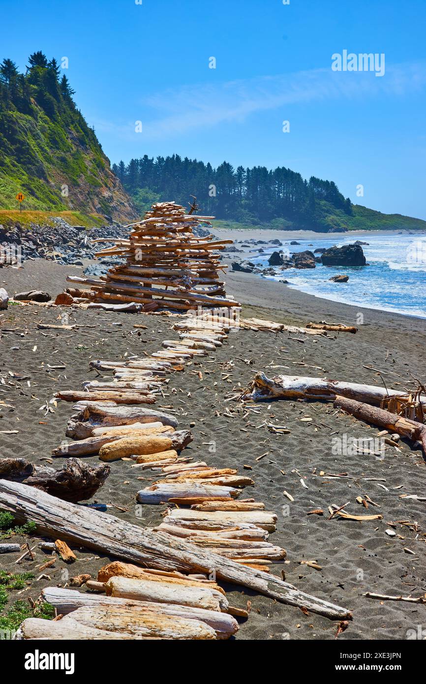 Driftwood Pyramid on Rugged Beach with Ocean Horizon View Stock Photo ...
