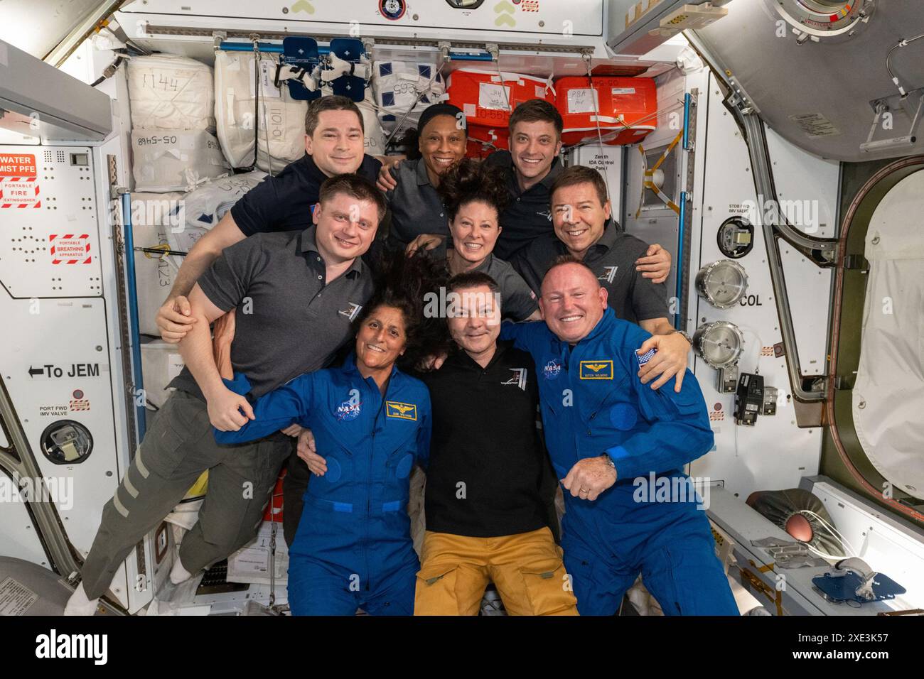 In this file photo, the seven Expedition 71 crew members gather with ...