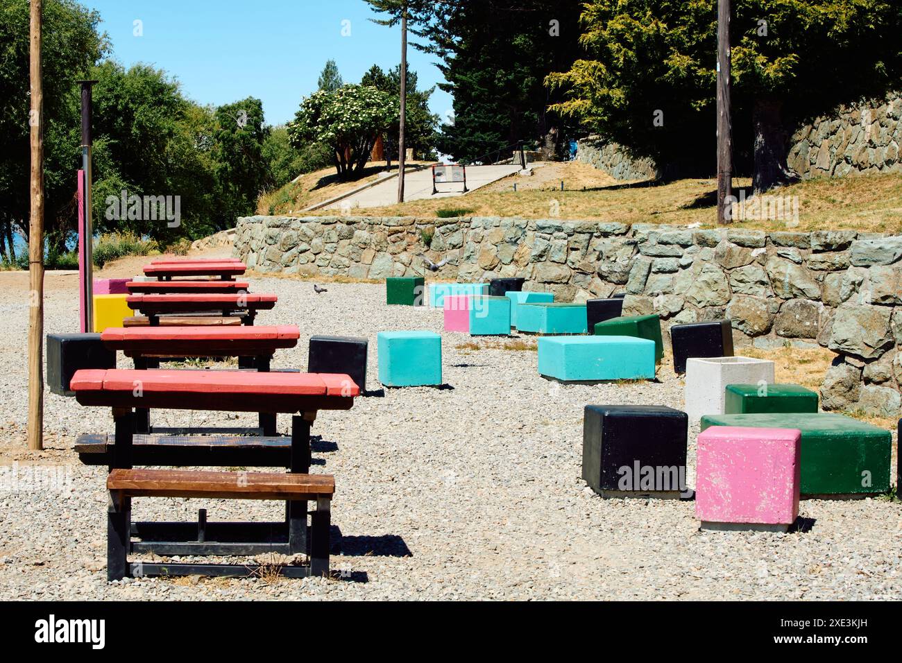 Multi-colored stone seats on the coast with tables and benches for ...