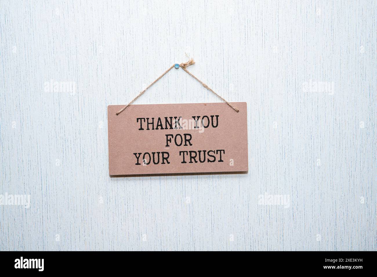 Thank you for your trust. text on white paper over torn paper background Stock Photo - Alamy