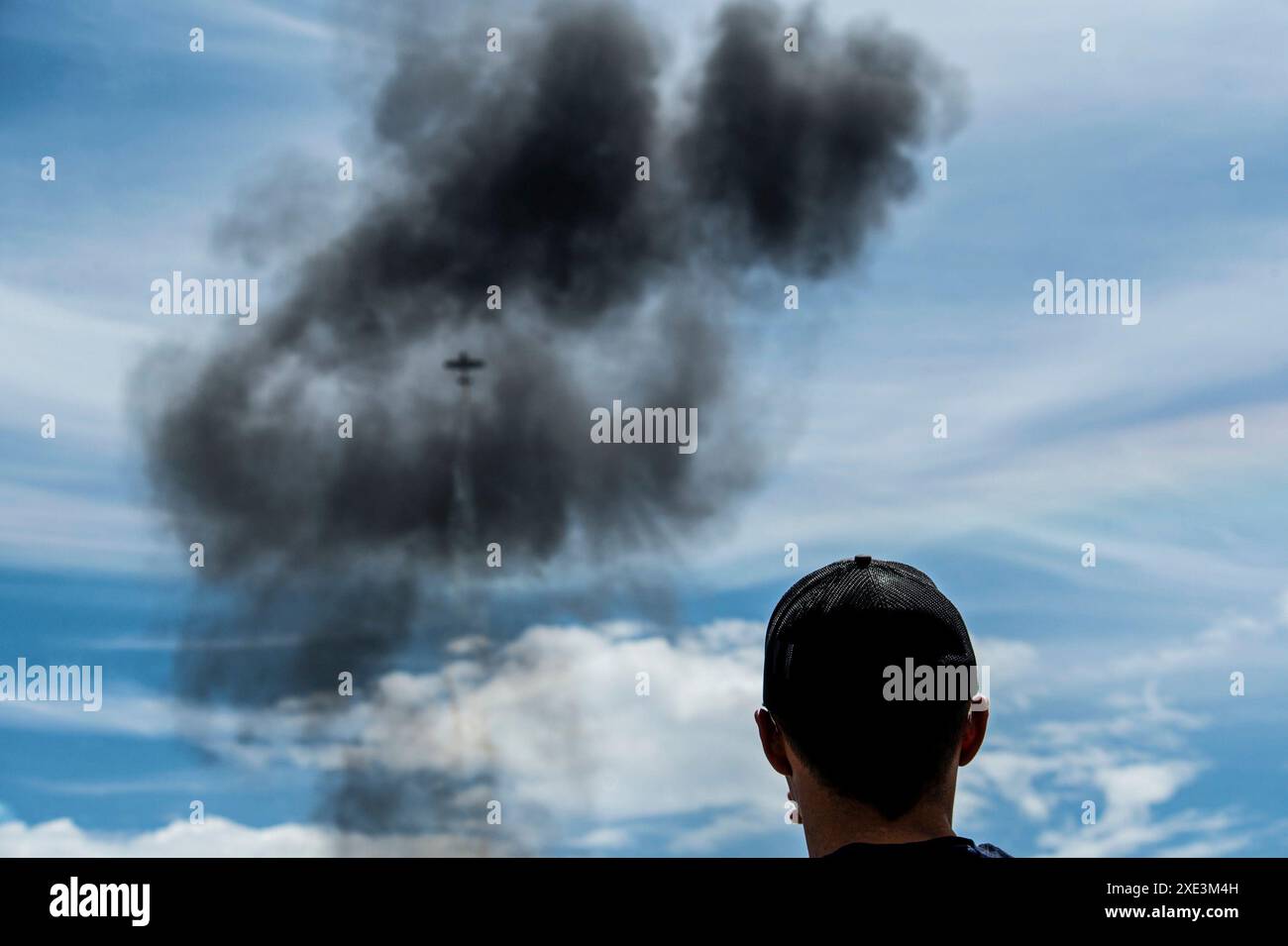 An airshow attendee watches Jon Melby in his Pitts S-1-11B “Fear Boss ...