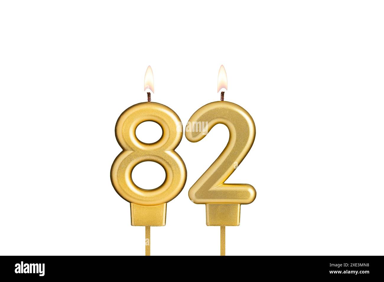 Golden number 82 birthday candle on white background Stock Photo - Alamy