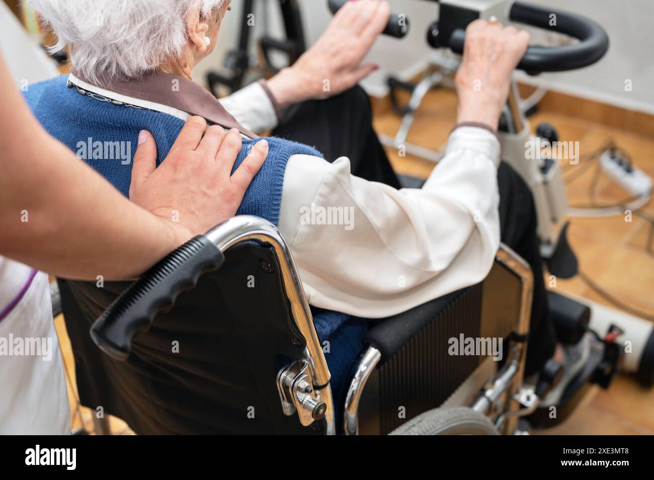 Close up nurse touch shoulder of elderly patient woman in wheelchair ...
