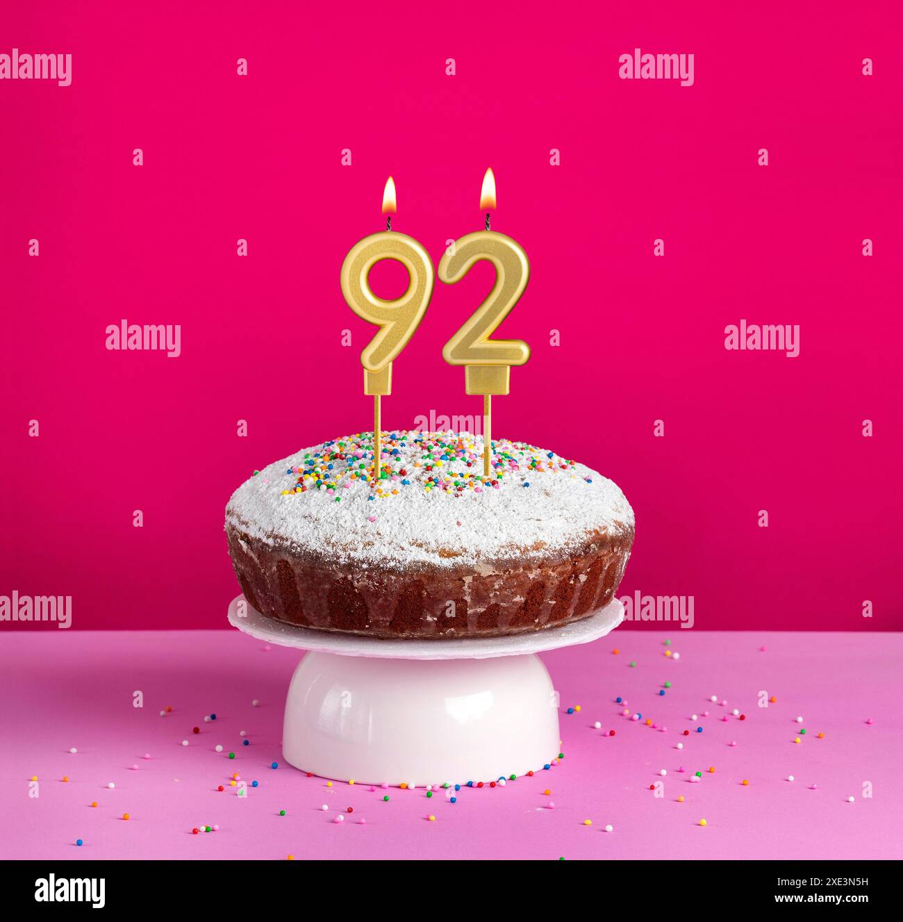 Lighted birthday candle number 92 - Birthday card on pink background ...