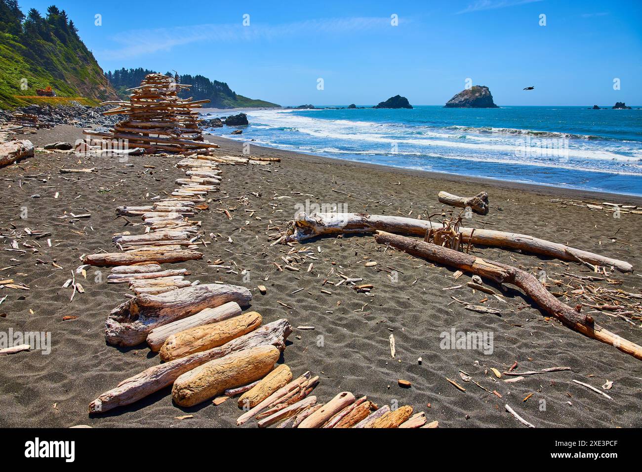 Driftwood Pyramid Art on Sunny DeMartin Beach with Coastal Landscape ...