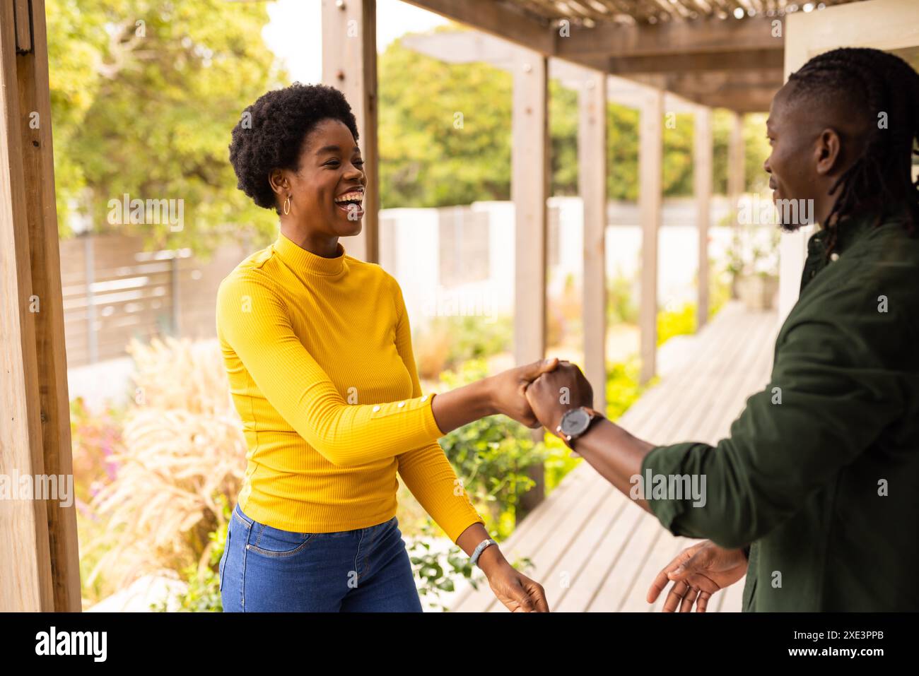 Outdoors, Couple smiling and greeting each other with handshake on ...