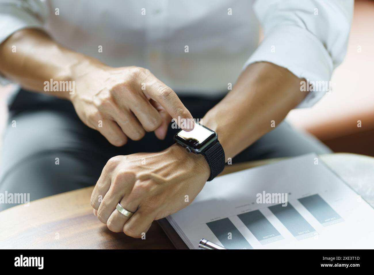 Business man Looking atÂ smart watch In Office online connect Gadget ...