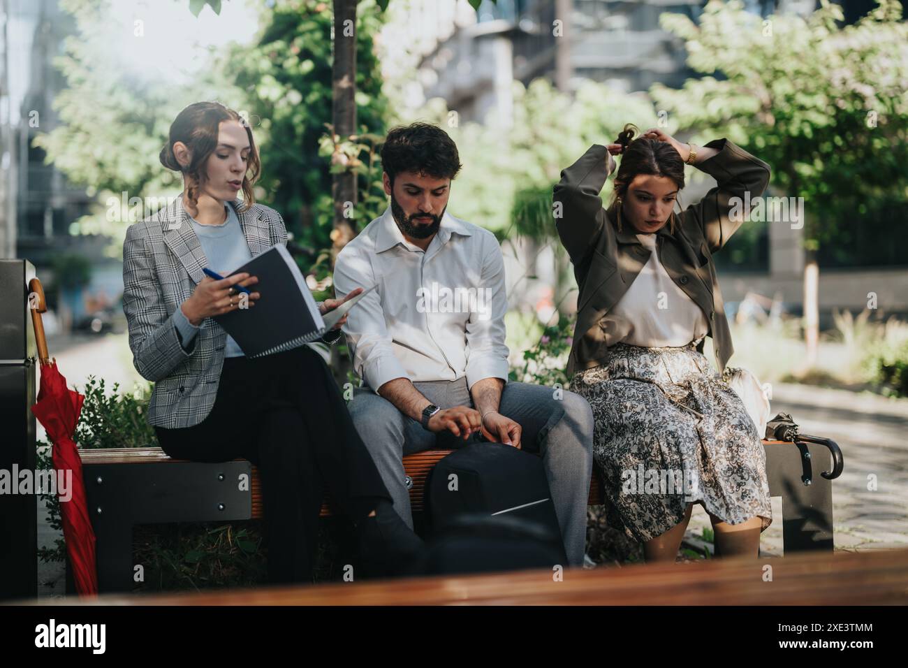Young business people brainstorming project ideas in an outdoor meeting ...