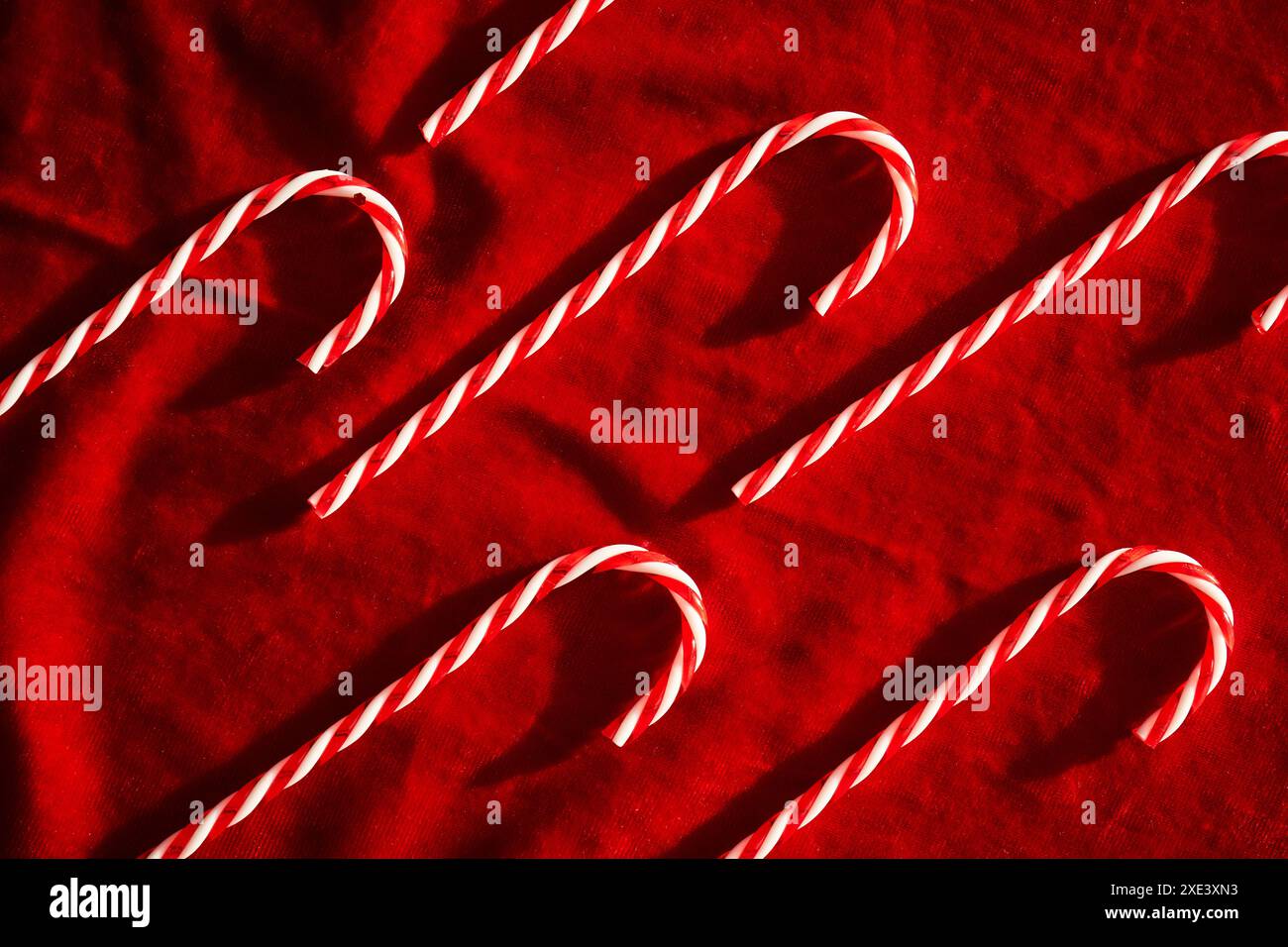 Christmas candy canes on burgundy velvet background Stock Photo - Alamy