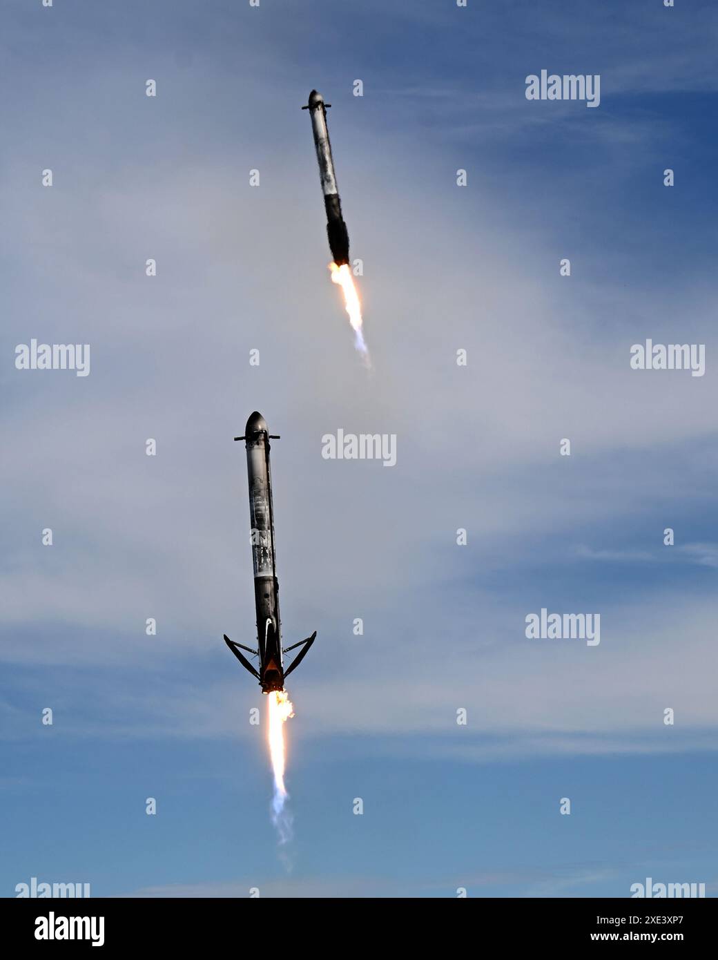 The side boosters of a SpaceX Falcon 9 Heavy rocket return to Landing ...