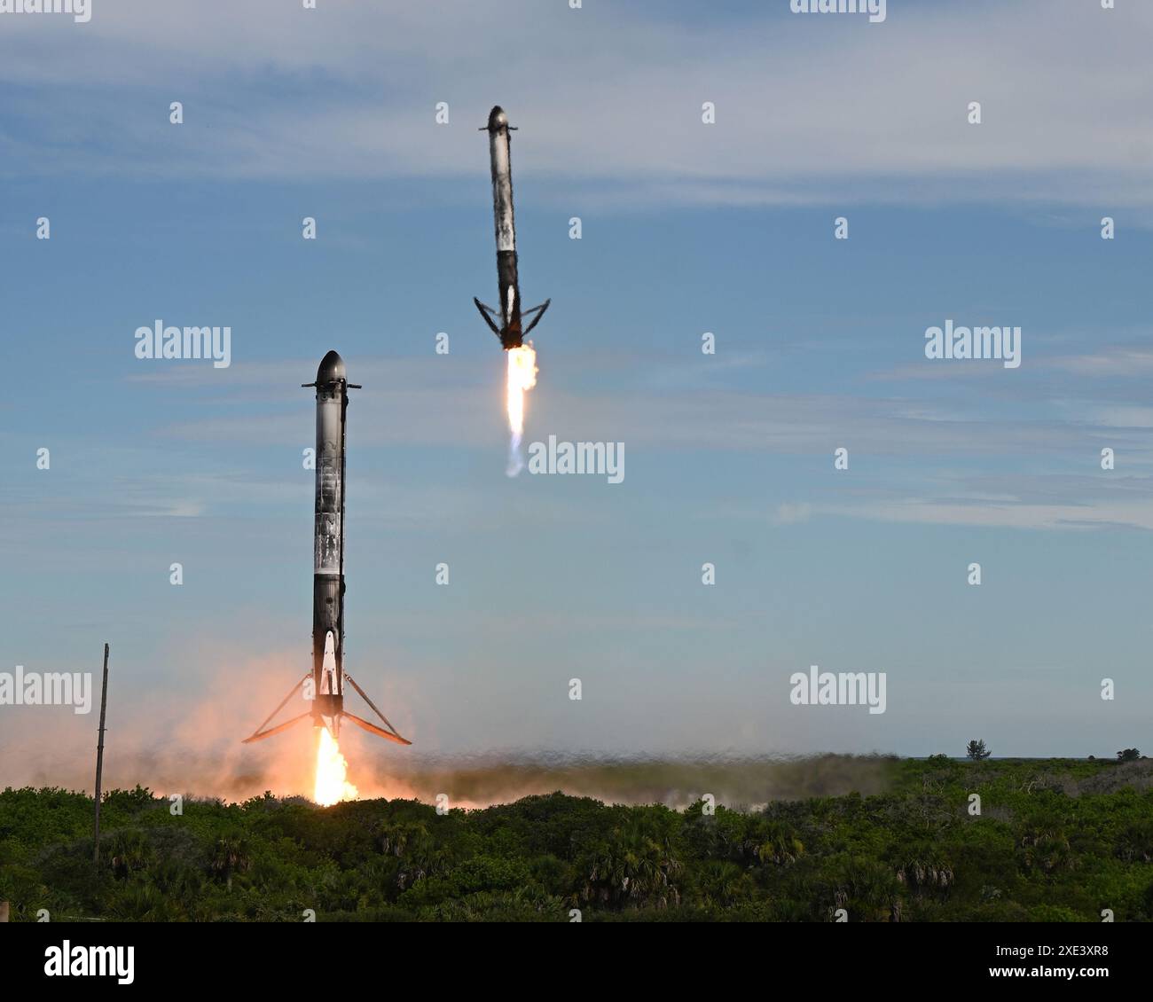 The side boosters of a SpaceX Falcon 9 Heavy rocket return to Landing ...