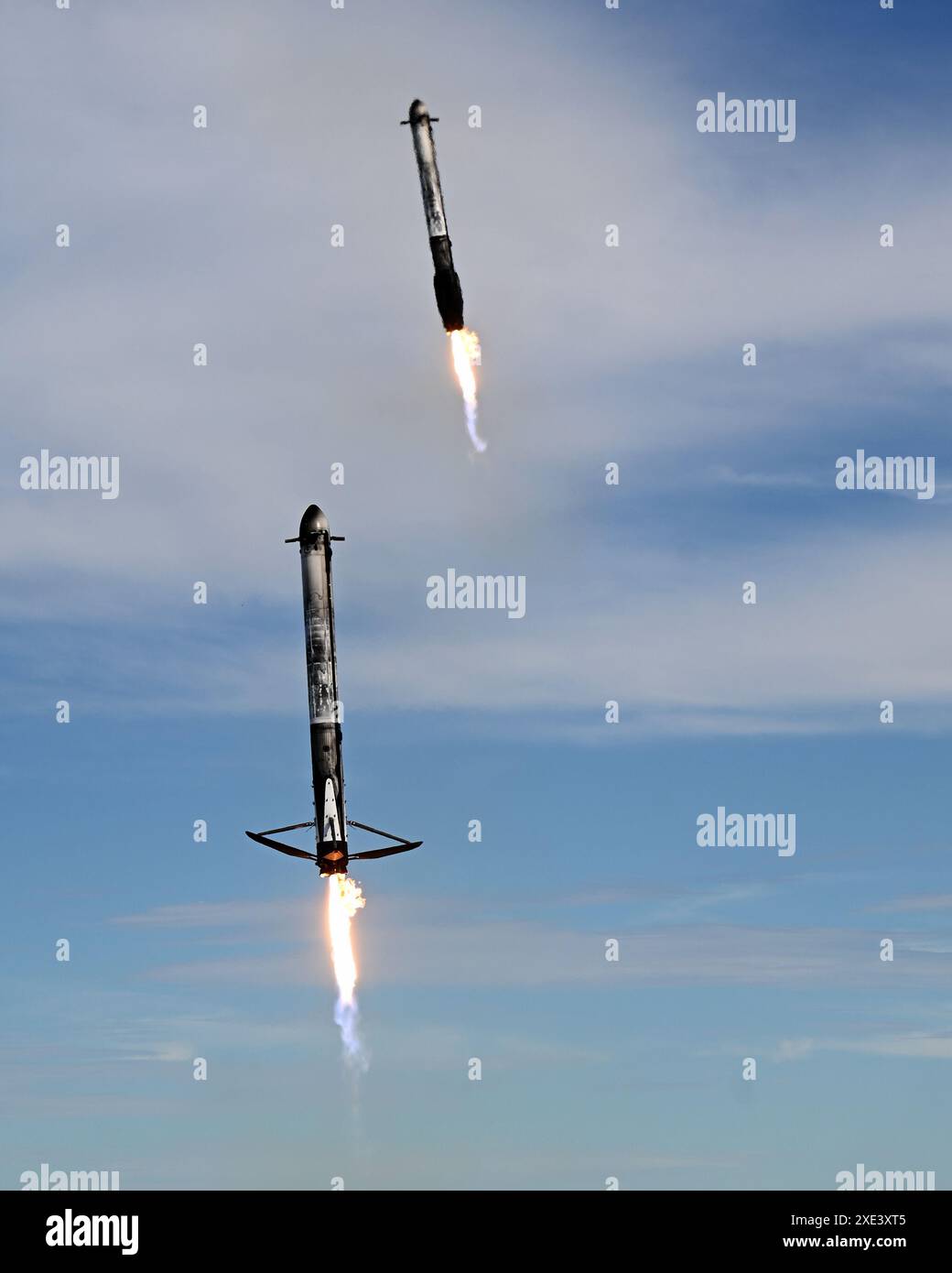 The side boosters of a SpaceX Falcon 9 Heavy rocket return to Landing ...