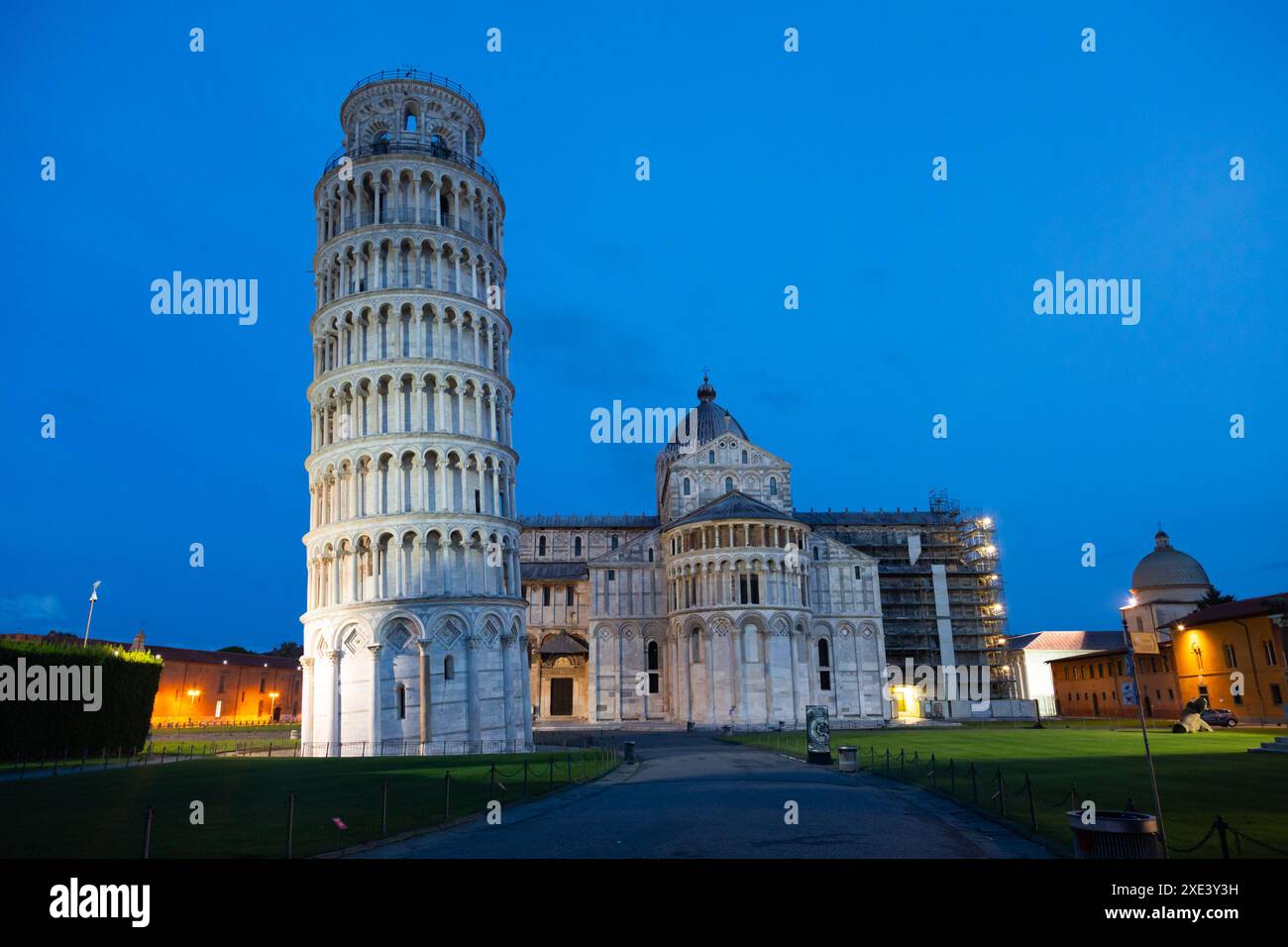 Pisa, Italy - leaning tower and cathedral panorama by night, blue sky ...