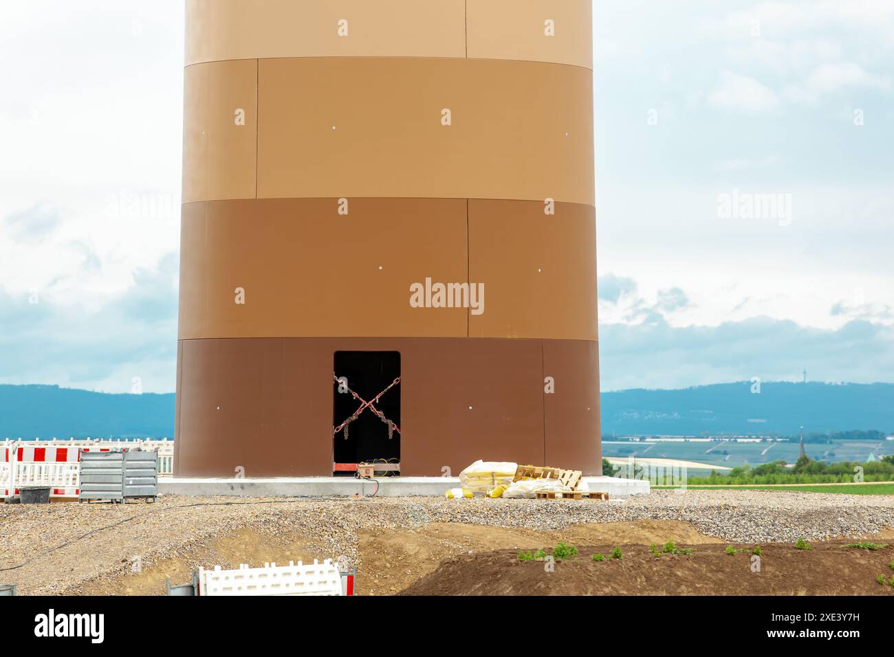 Building and assembling a construction windmill by crane. Farmland with ...