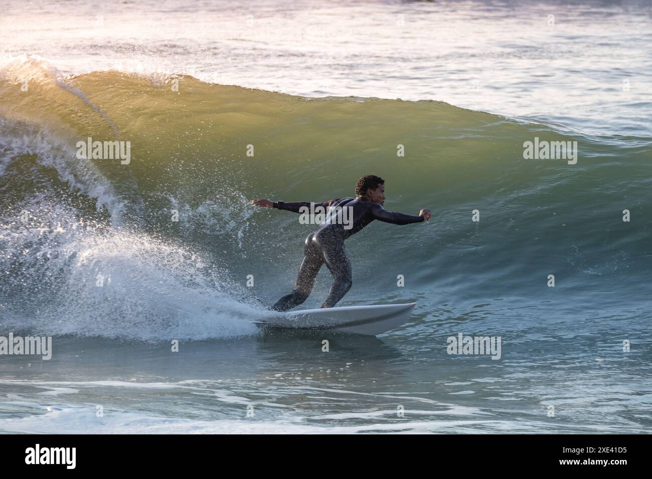 Young surfer enjoying waves Stock Photo - Alamy