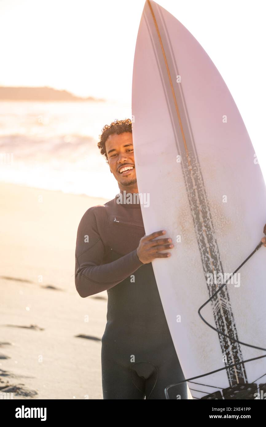 Holding her surfboard hi-res stock photography and images - Alamy