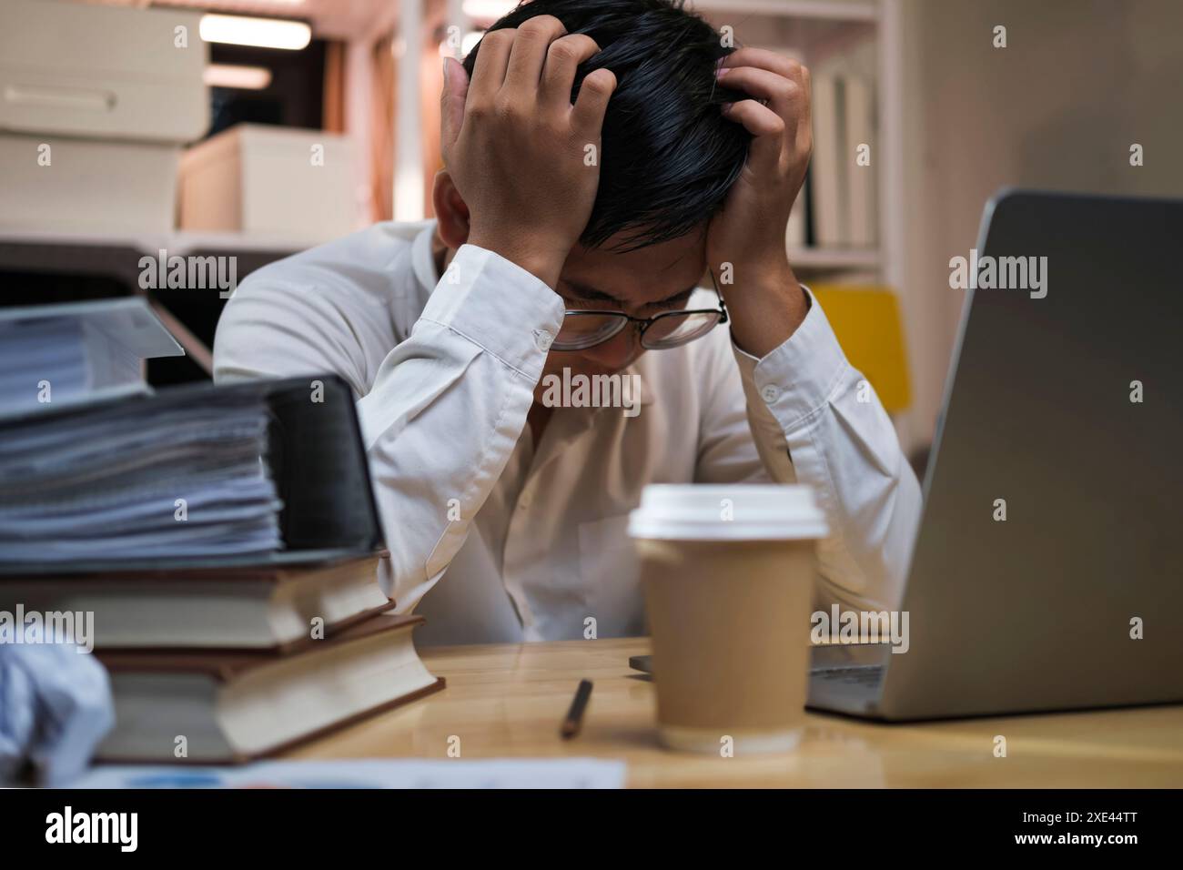 Asian young tired staff businessman using desktop computer having ...