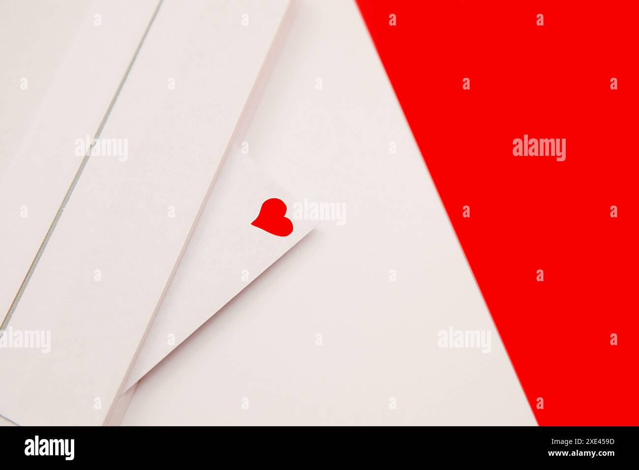 Stack of white mail letters with a love heart scribbled on a single ...