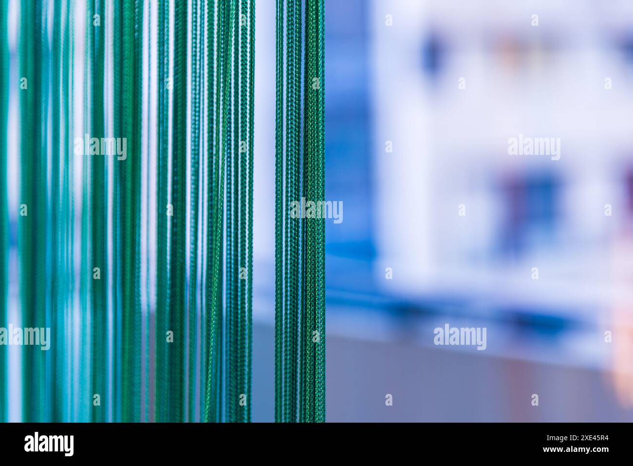 Turquoise Color String Curtain Close-up In Front Of Building Background ...