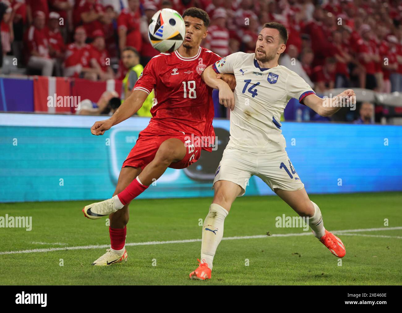 Munich, Germany. 25th June, 2024. Alexander Bah (L) of Denmark vies ...