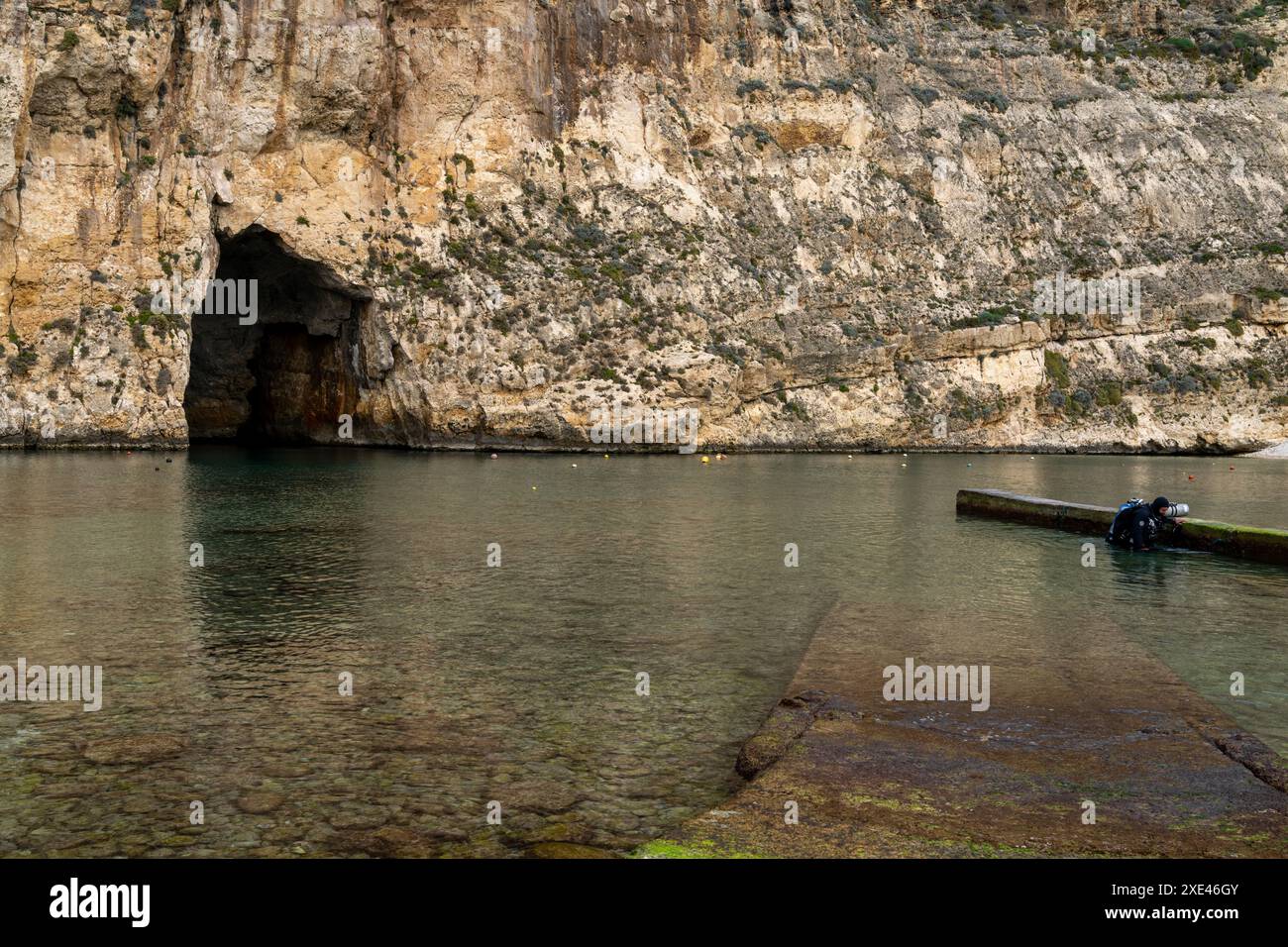 A scuba diver preparing to go diving in the Inland Sea and Blue Hole ...