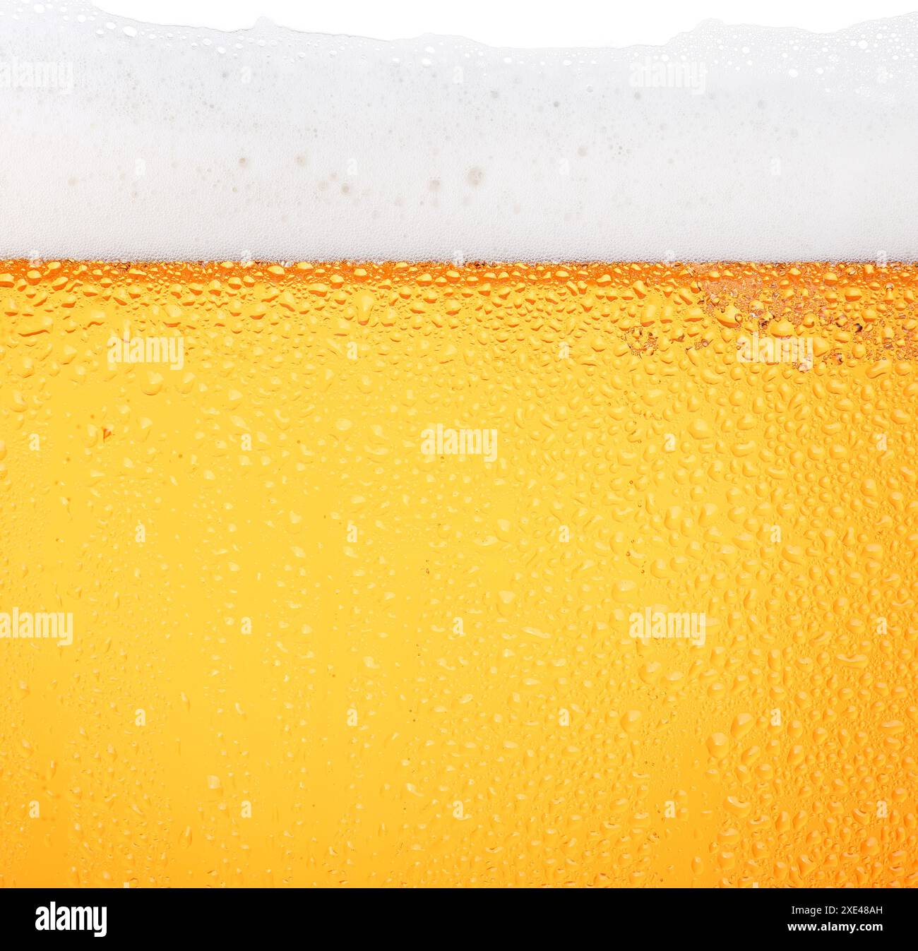 Close up background texture of pouring lager beer with bubbles and ...