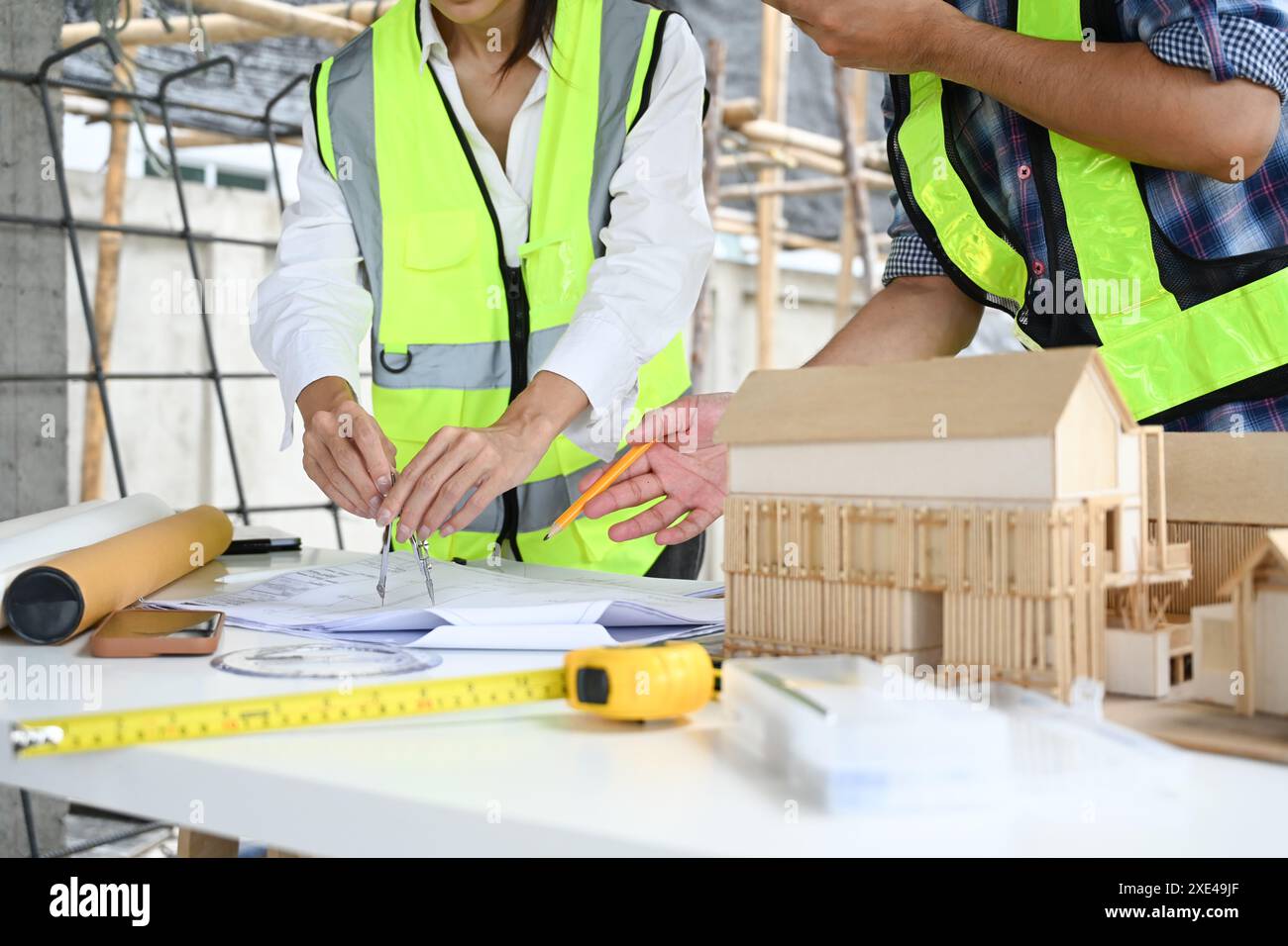 Engineer team having briefing about project reviewing blueprints at a ...