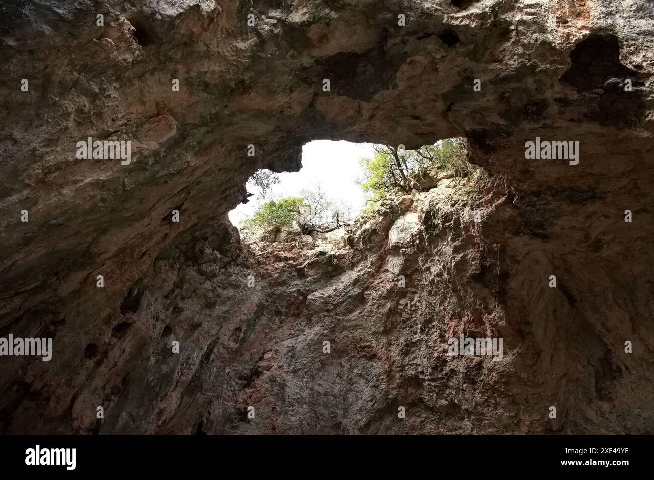 Low angle view of the opening of a cave from the bottom Stock Photo - Alamy