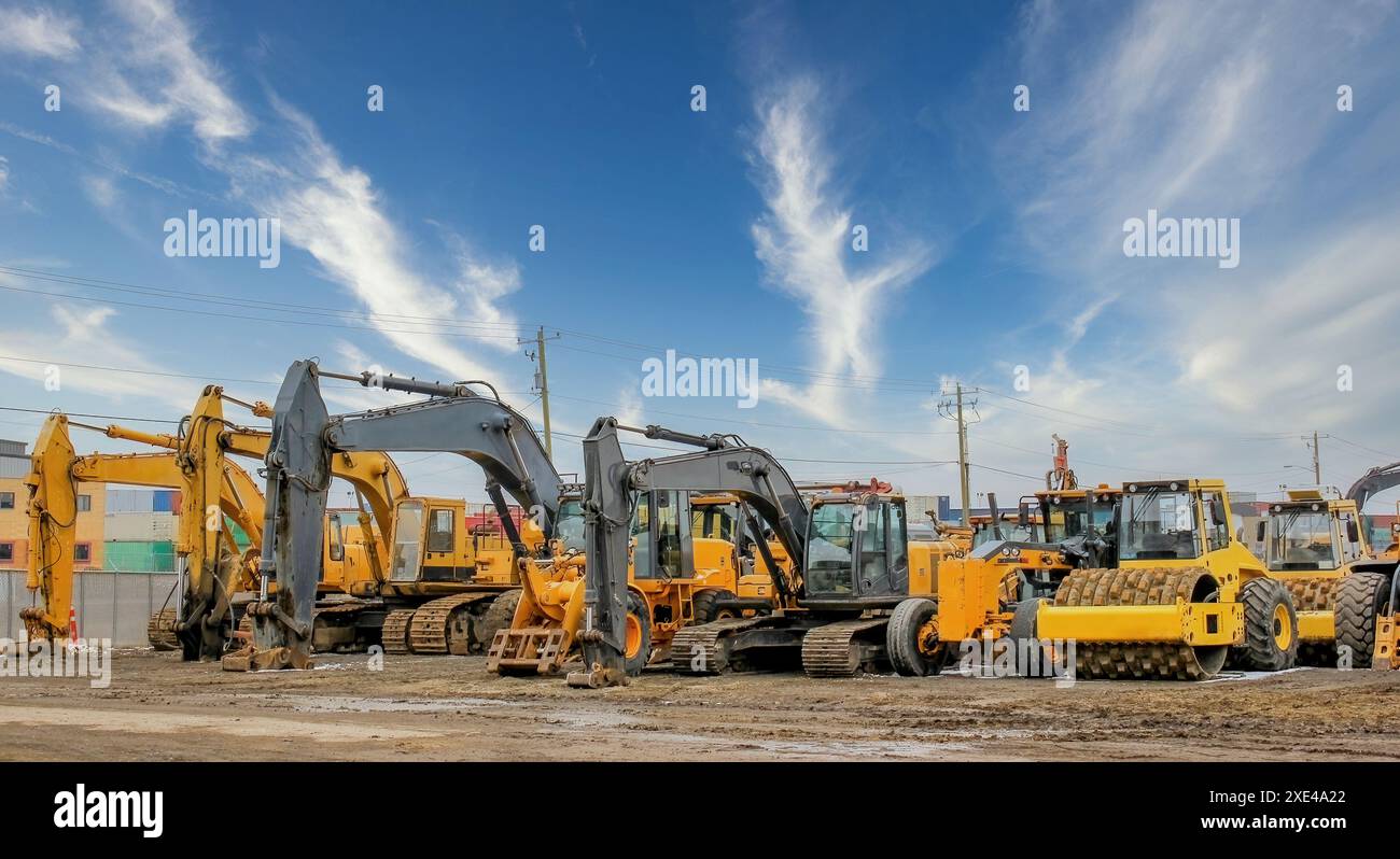 Various heavy construction vehicles, such as excavators, diggers ...