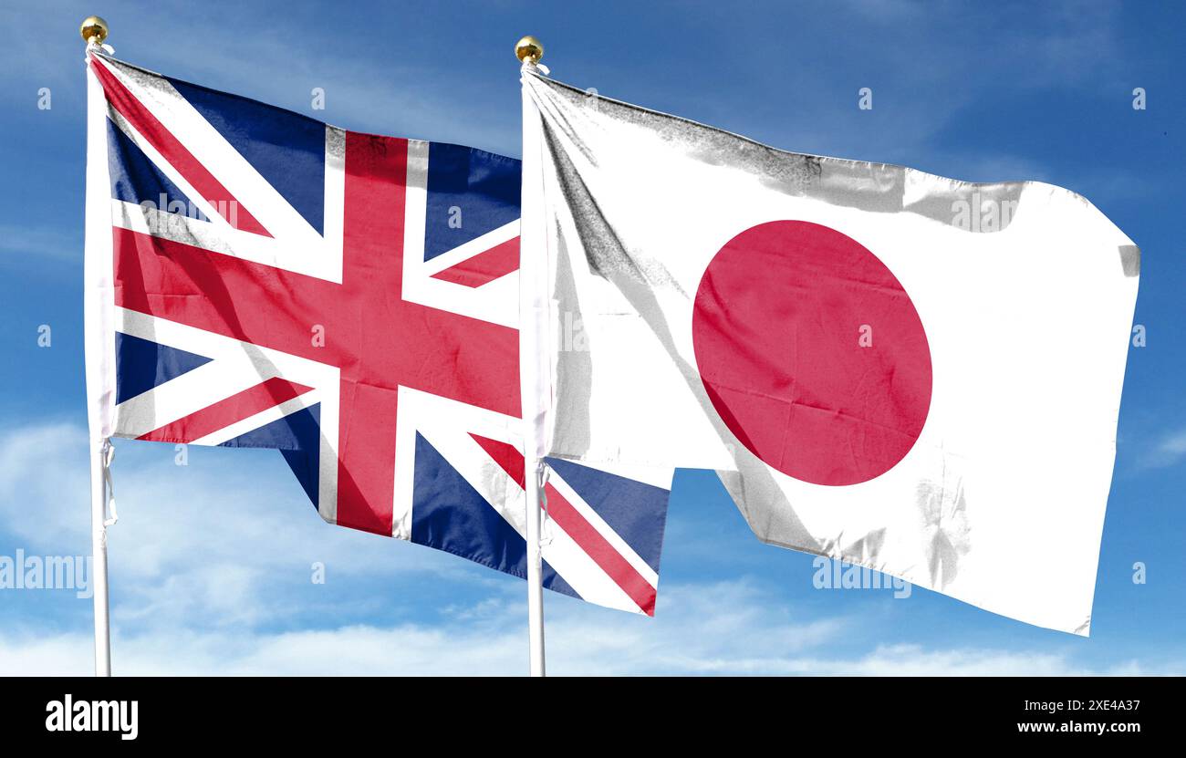 Flags of Japan and Great Britain against cloudy sky. waving in the sky ...