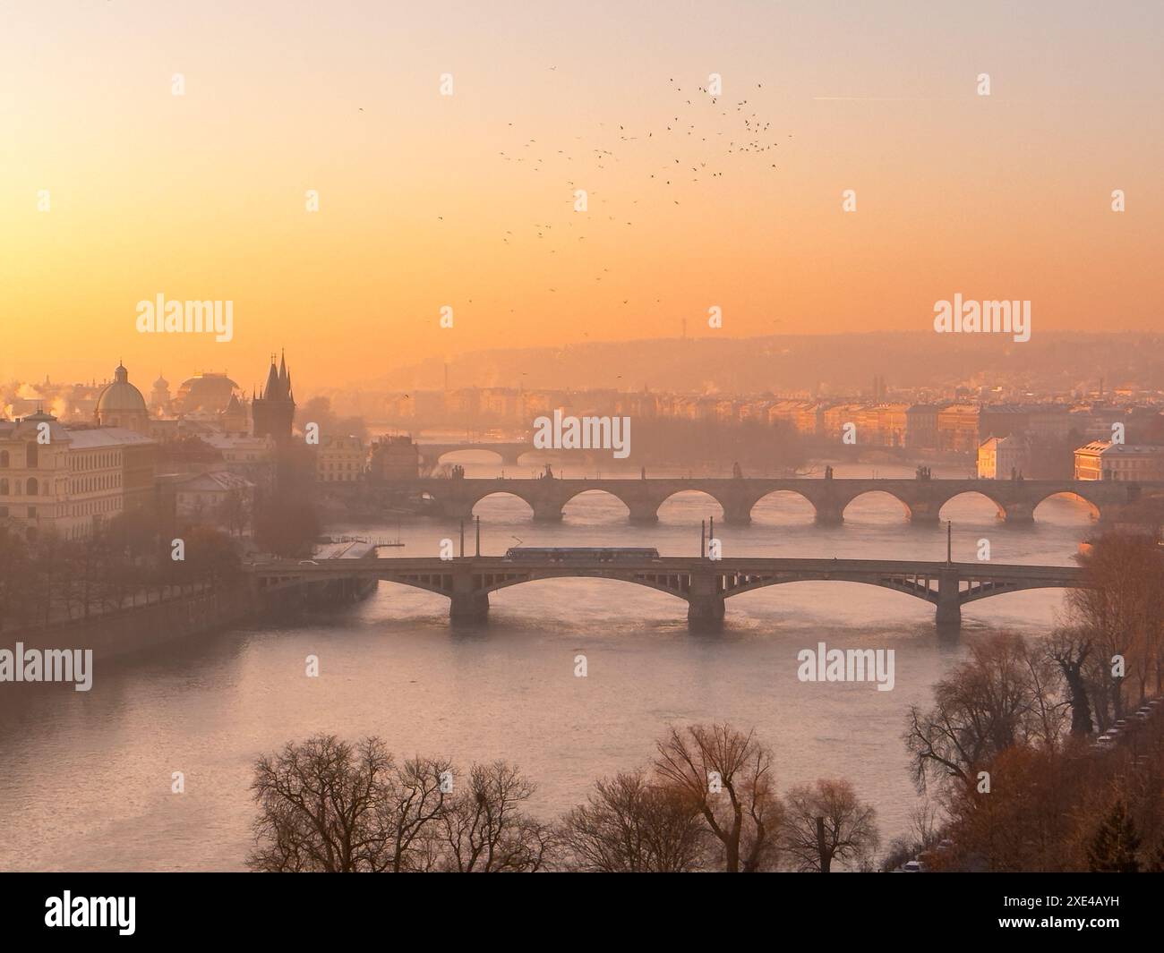 Prague bridge over a river with a city in the background Stock Photo ...