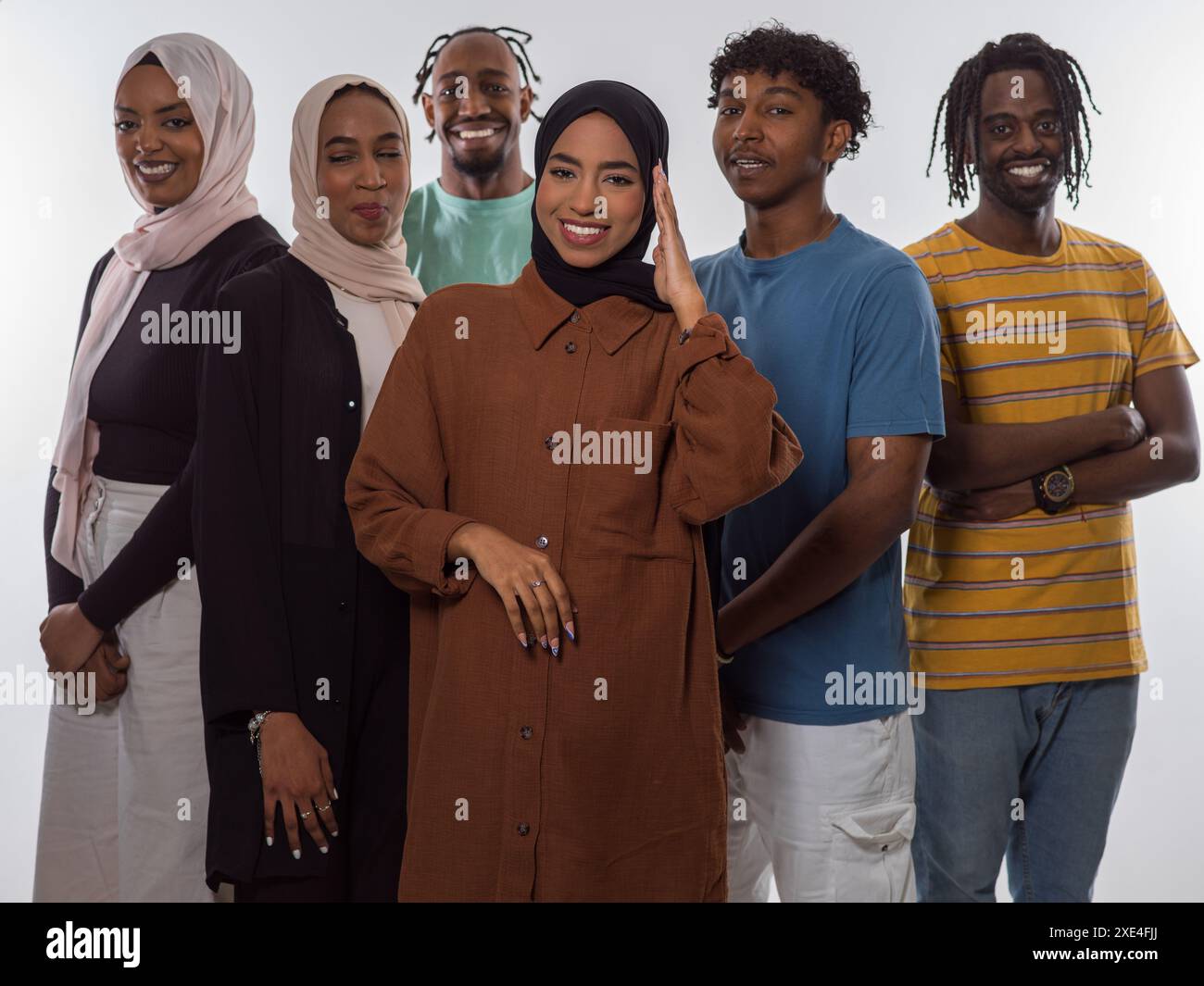 A diverse group of teenagers strikes dynamic poses with smiles and ...