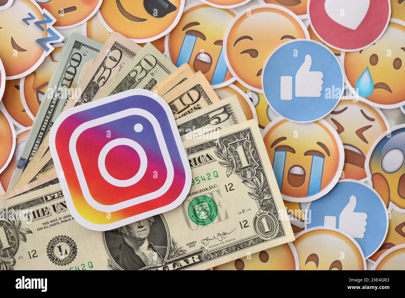 KYIV, UKRAINE - APRIL 20, 2024 Instagram logo and many usd money bills ...