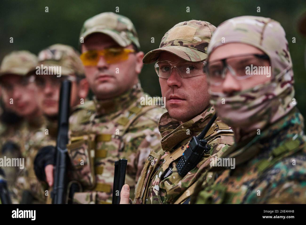 Soldier fighters standing together with guns. Group portrait of US army ...