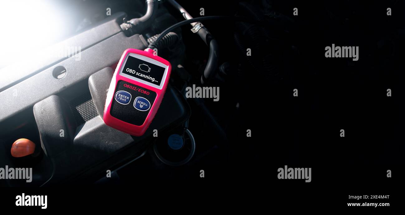 OBD2 or OBD scanner tool on car engine compartment for engine system ...