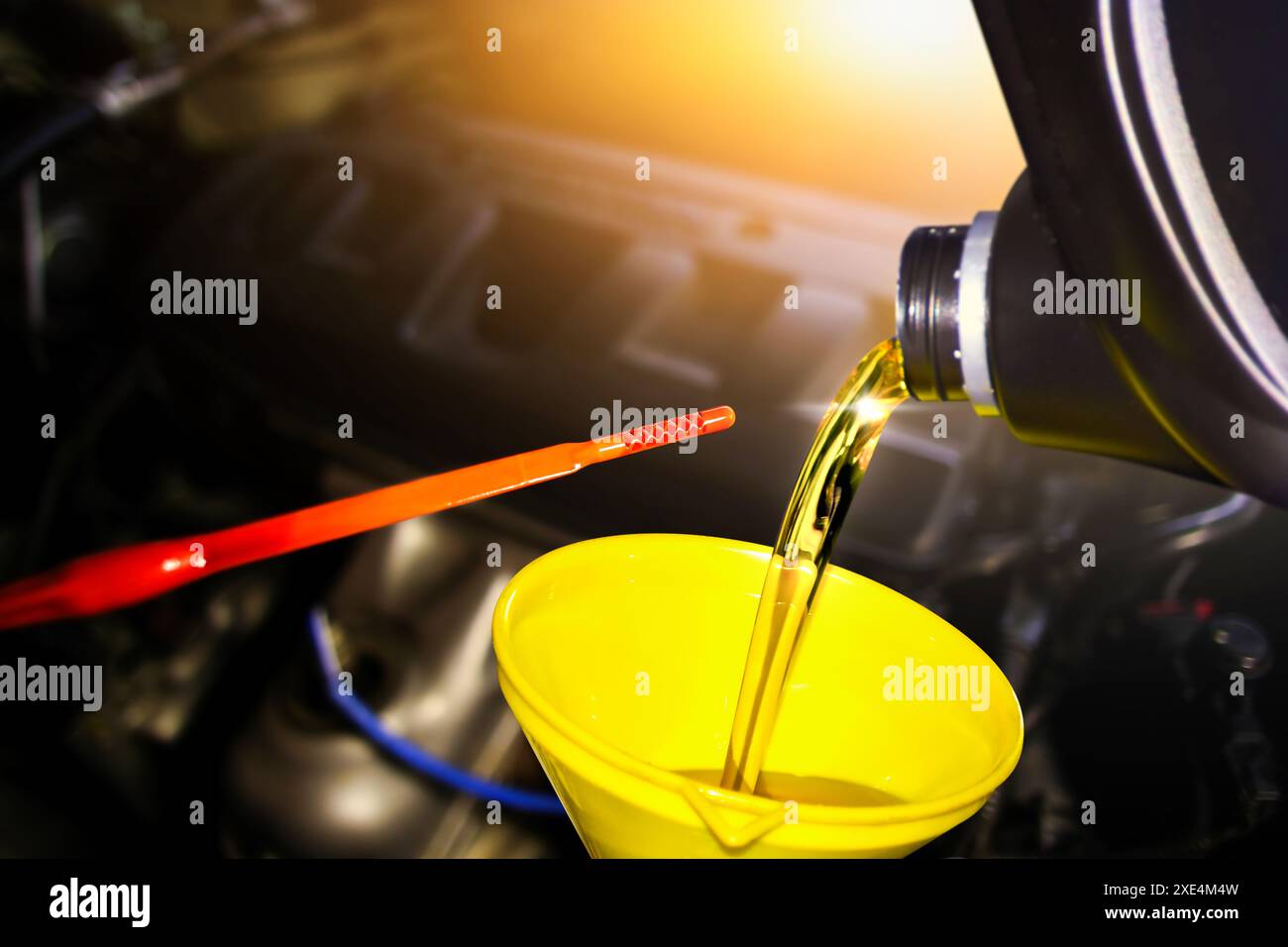 Car maintenance service , Pouring engine oil into a funnel for car ...