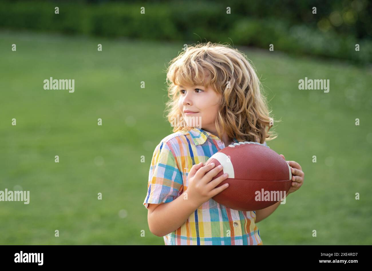 Portrait of child with rugby ball. American football. Child ready to ...