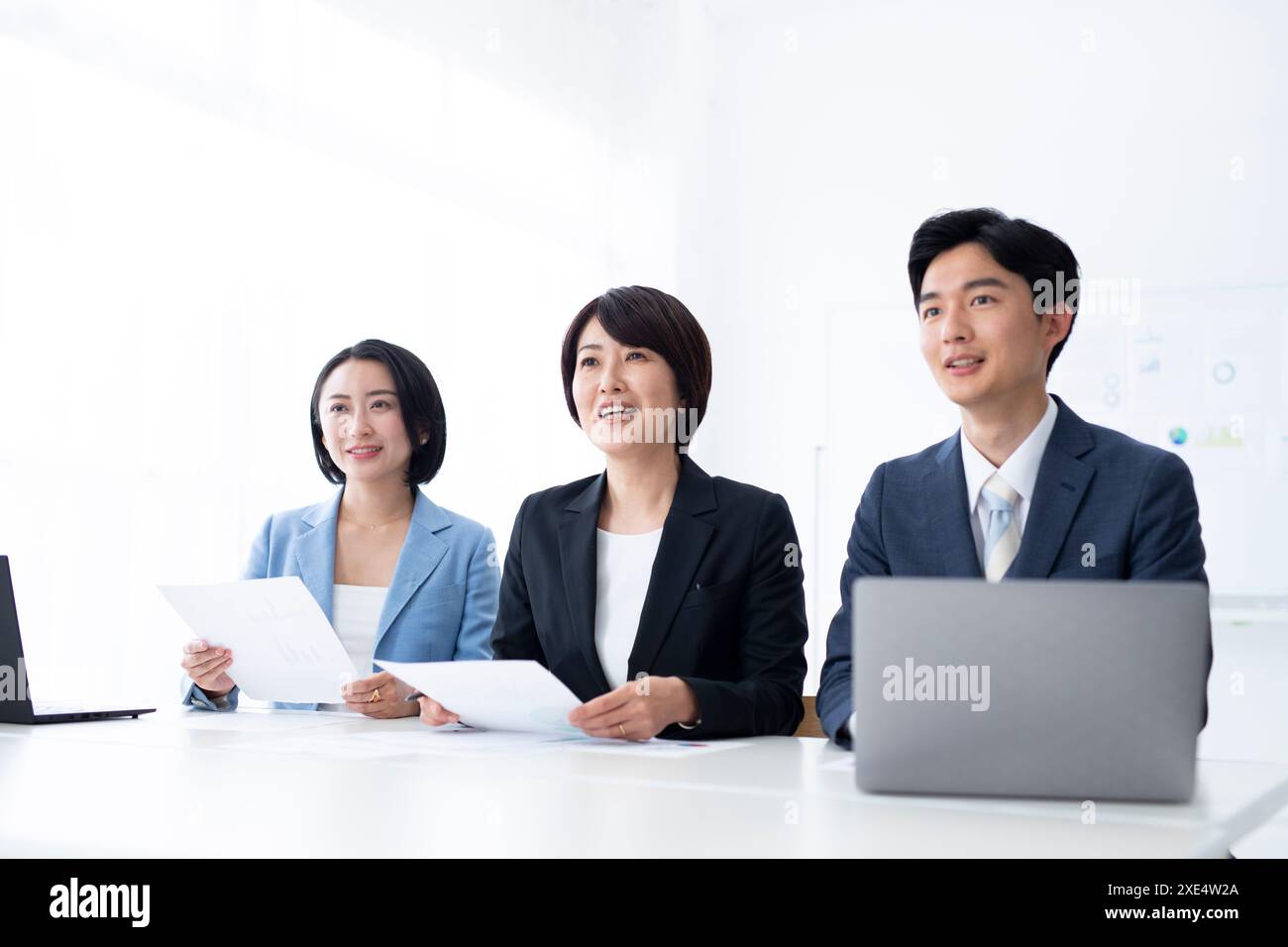 Three men and a woman interviewing in an office Stock Photo - Alamy