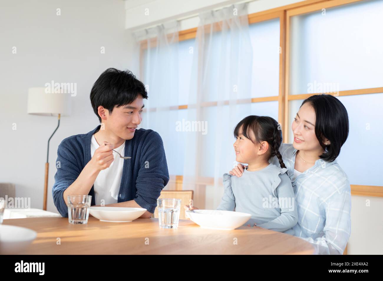 Family around the dining table Stock Photo - Alamy