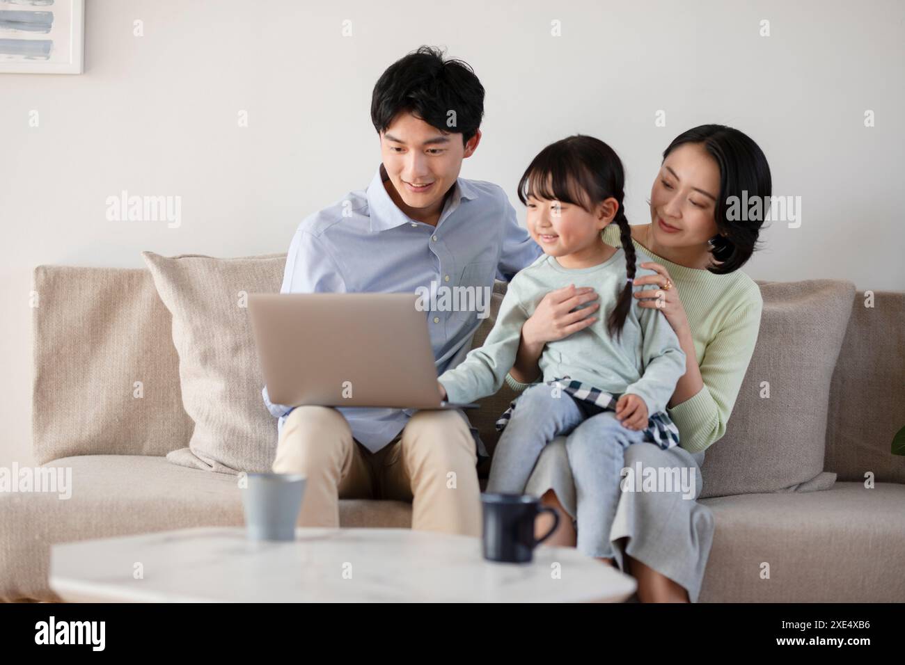 Family looking at computer Stock Photo - Alamy