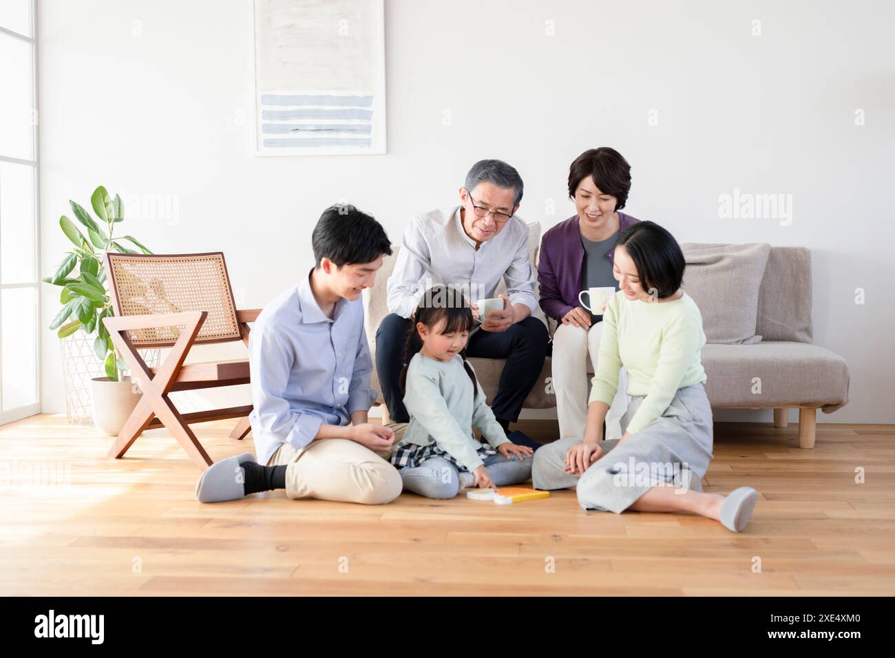 Family of three generations enjoying a meal in the living room Stock ...