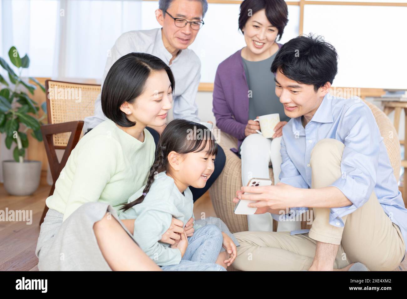 Family of three generations playing with their smartphones in the ...