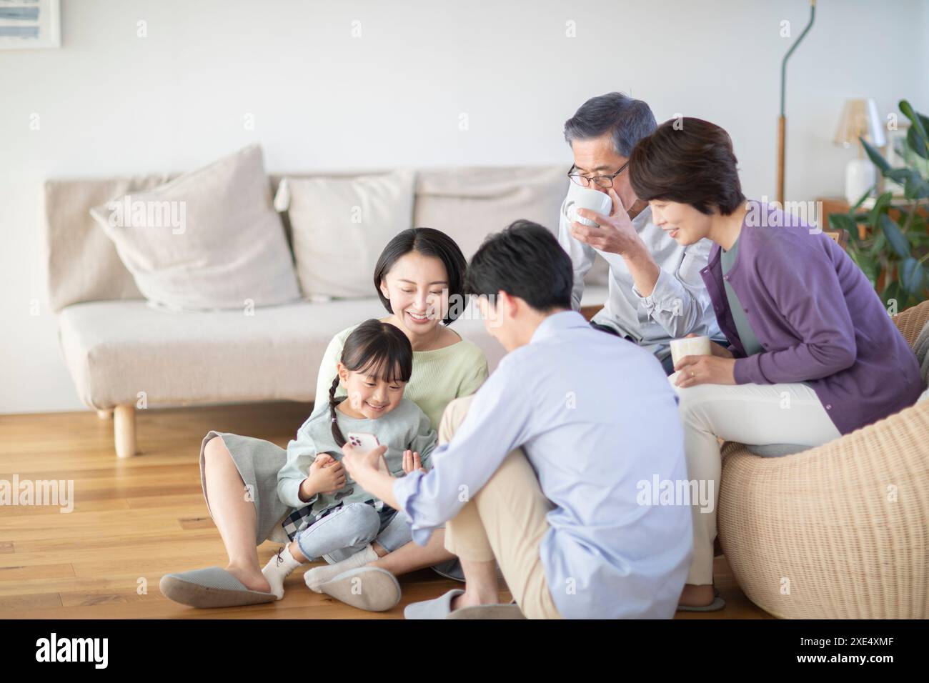 Family of three generations playing with their smartphones in the ...